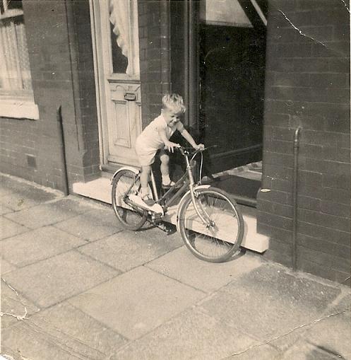 Harry Davies tries to ride a bike that is much too big for him in the ...